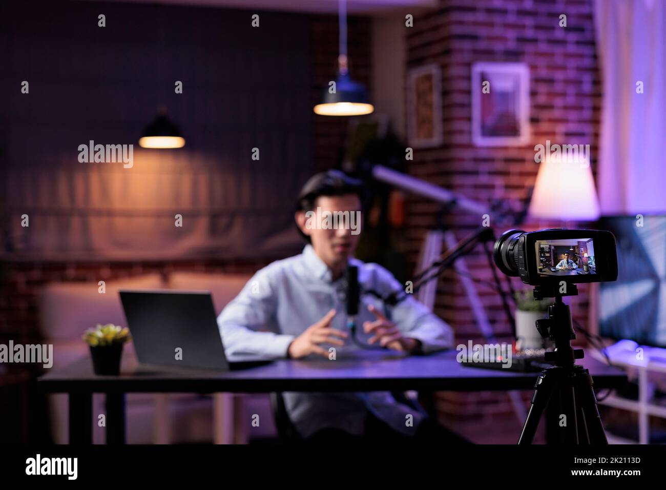 Content creator broadcasting talk show on camera, recording podcast ...