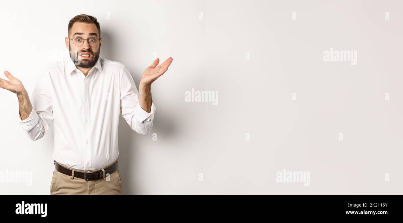 Clueless worried manager shrugging, looking confused, standing over ...