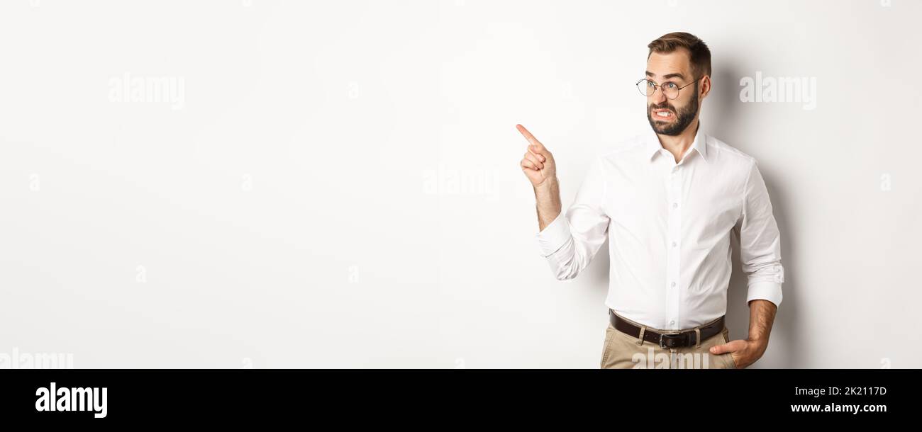 Young bearded guy seeing something disturbing, cringe while pointing ...