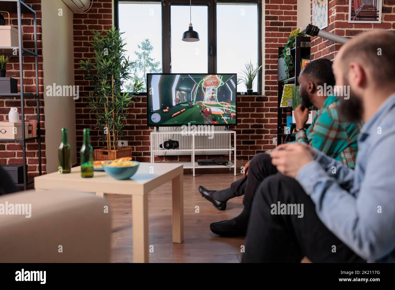 Multiethnic team of men using tv console to play shooting video games ...