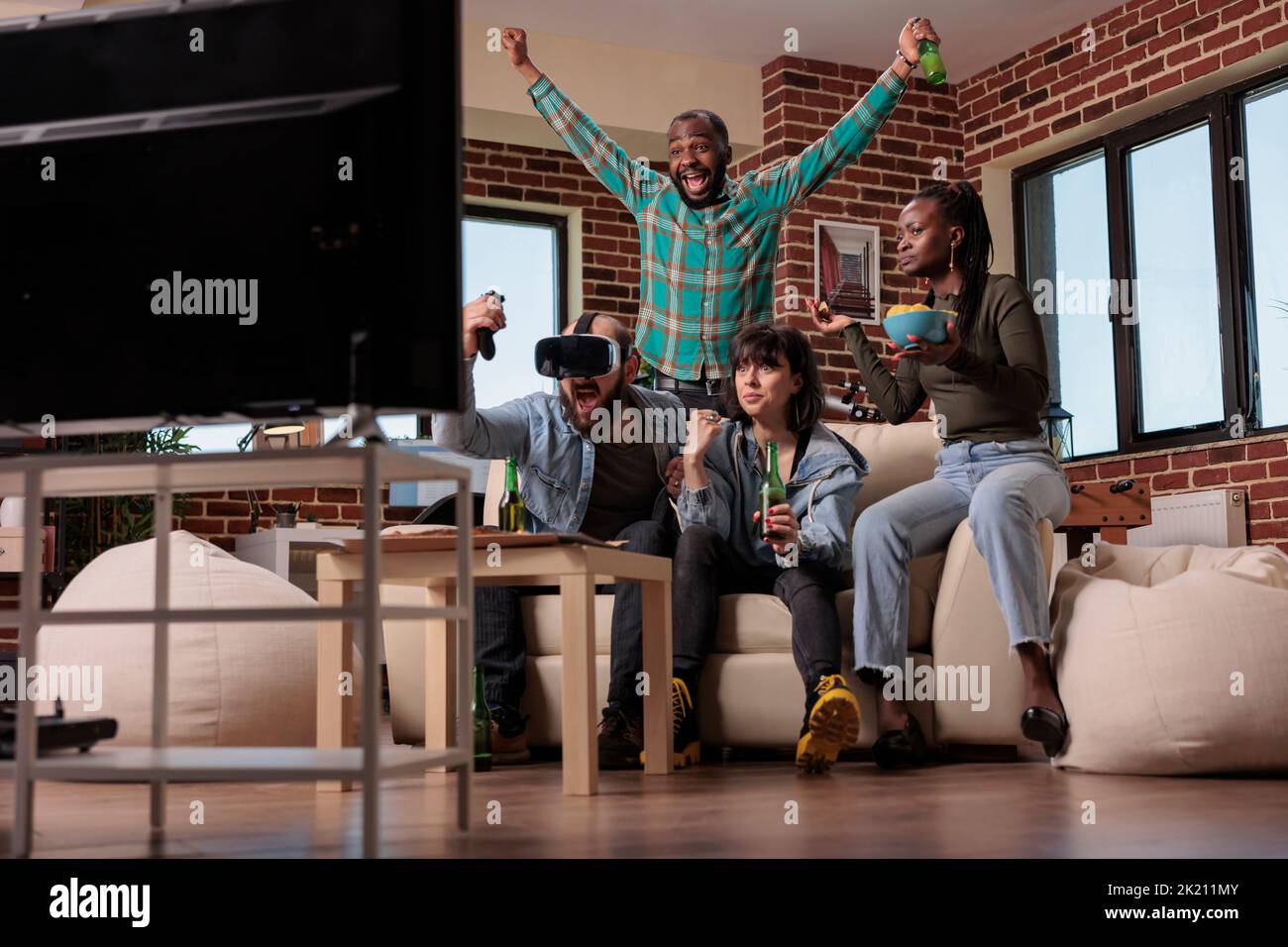 Group of diverse friends winning video games play on tv console, using ...