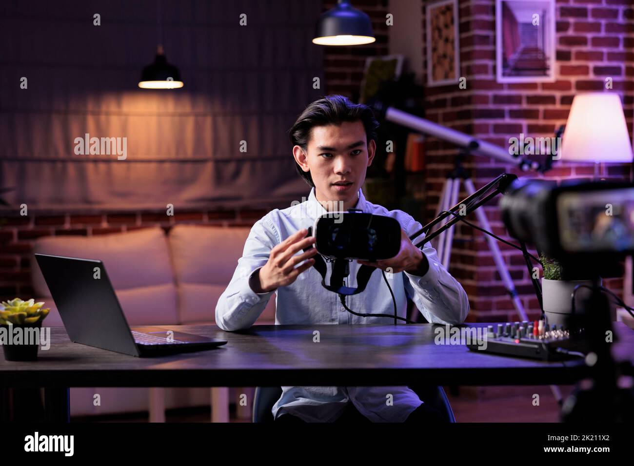 Lifestyle influencer filming product review with vr glasses ...