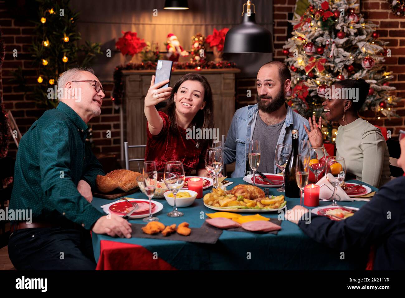 Woman taking family portrait selfie on smartphone, celebrating ...
