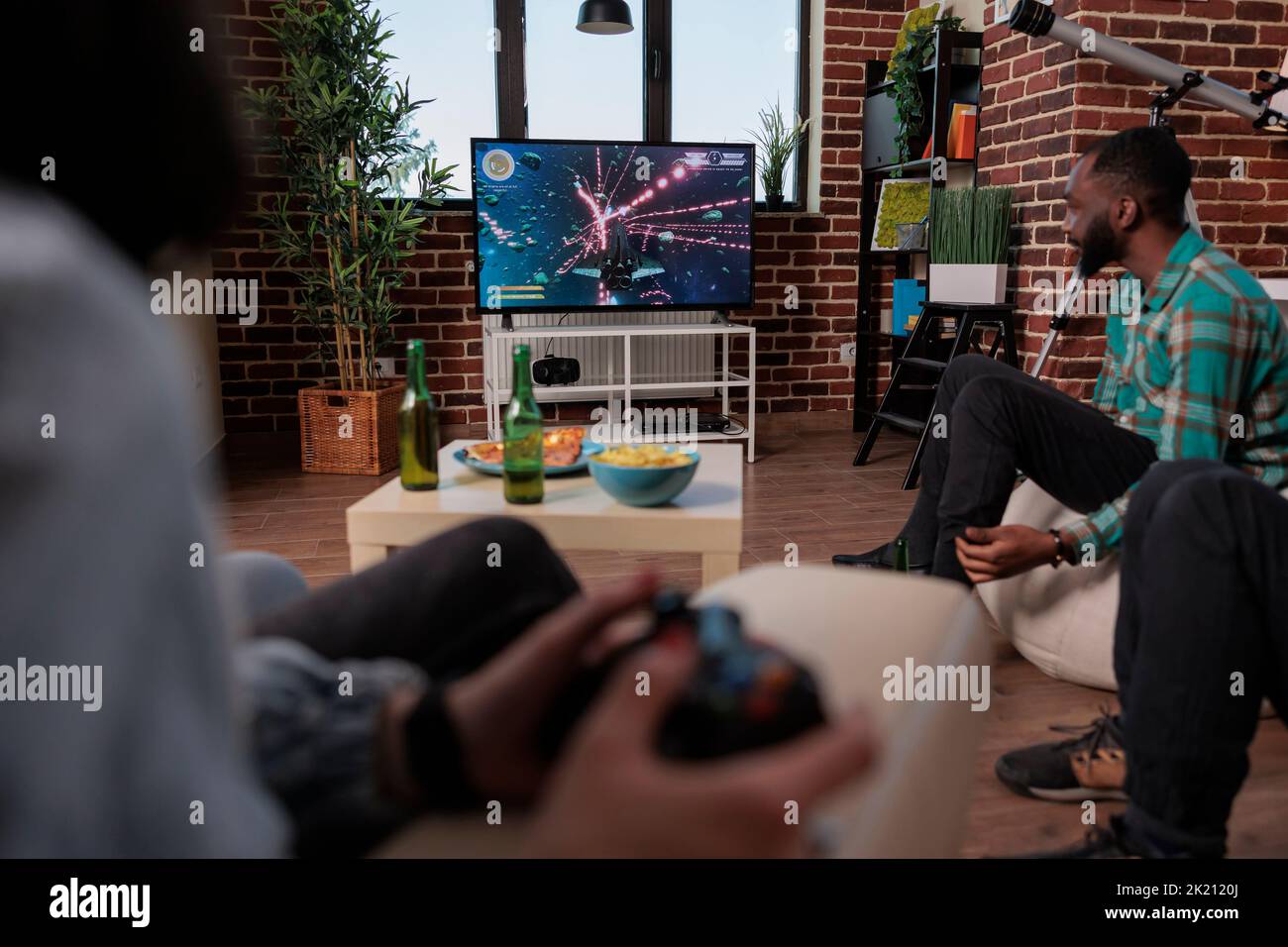 Men and women using tv console and joystick to play video games, having ...