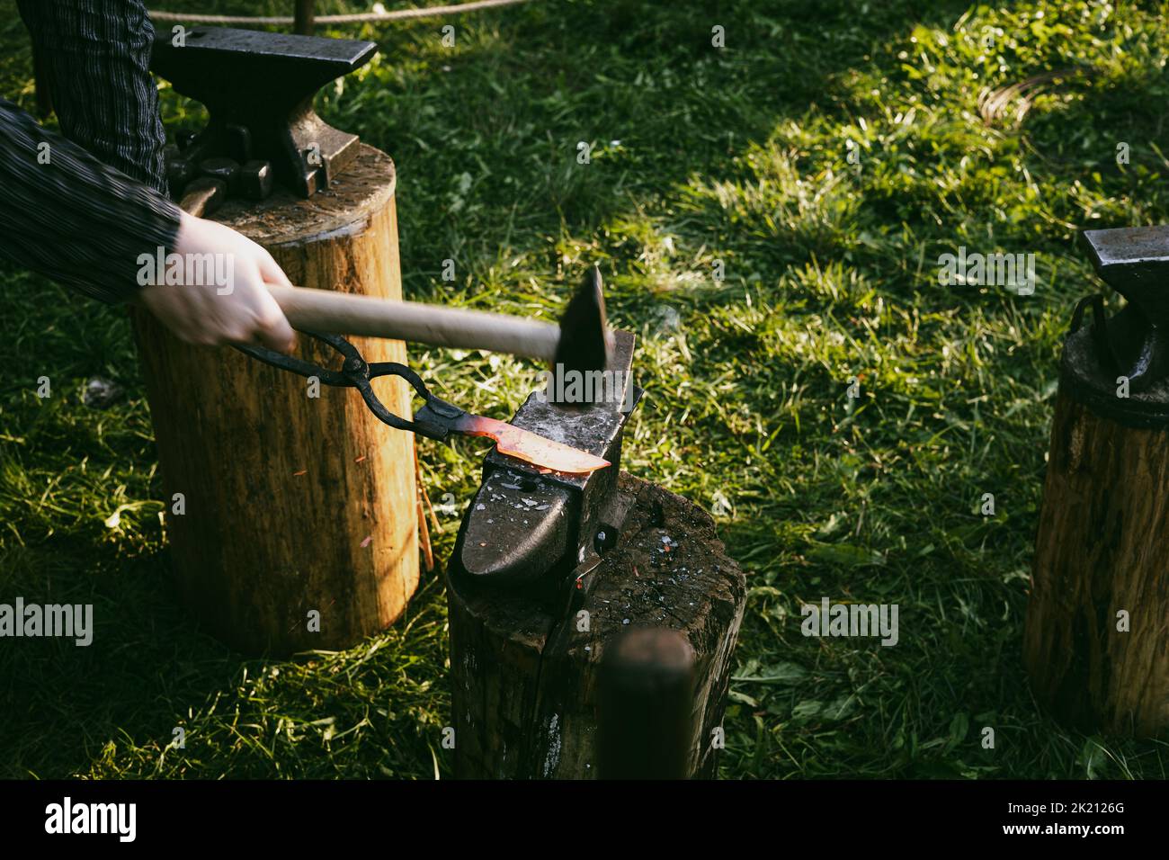 Blacksmith's workshop in the open air. The process of forging a knife ...