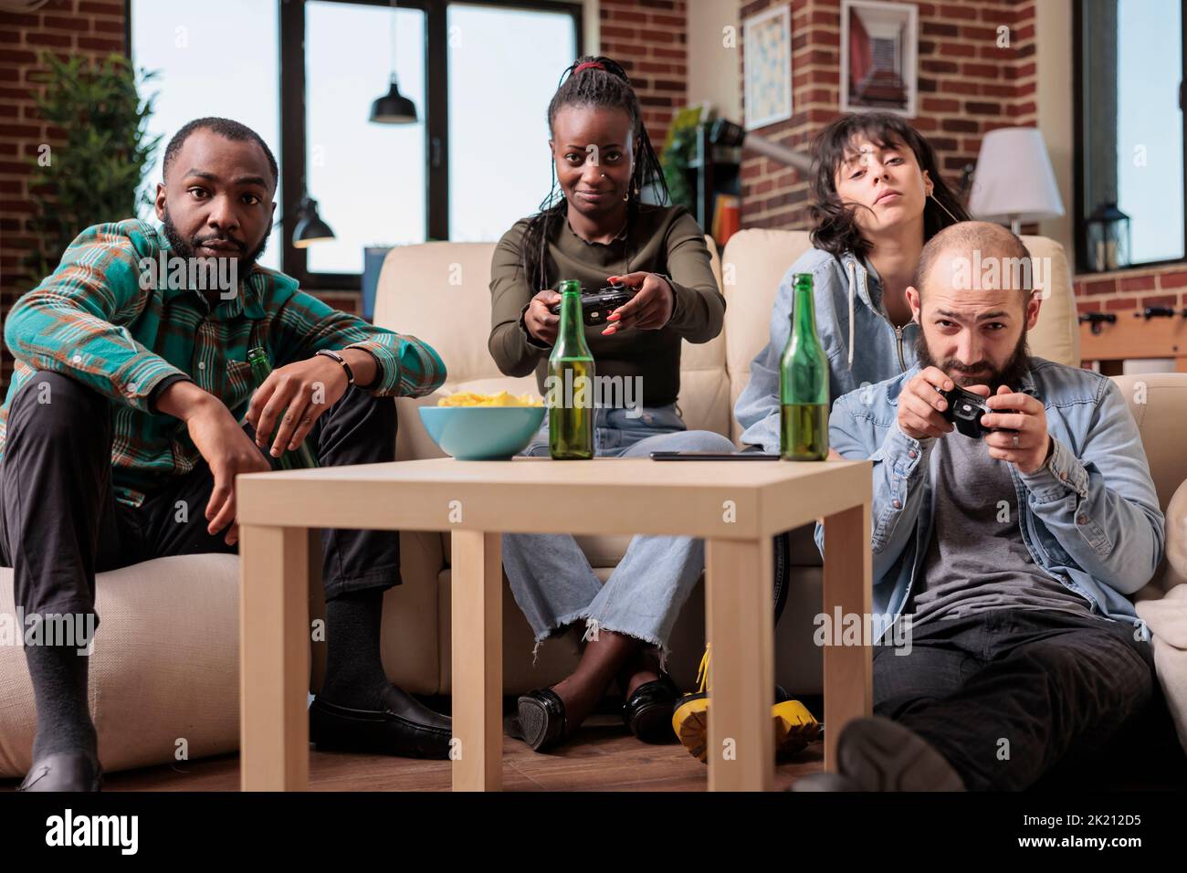 Diverse group of people using joysticks to play video games on ...