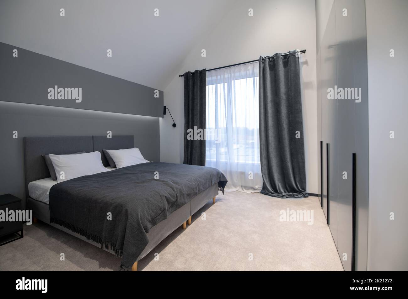 Bedroom with natural light coming in through the large window Stock ...