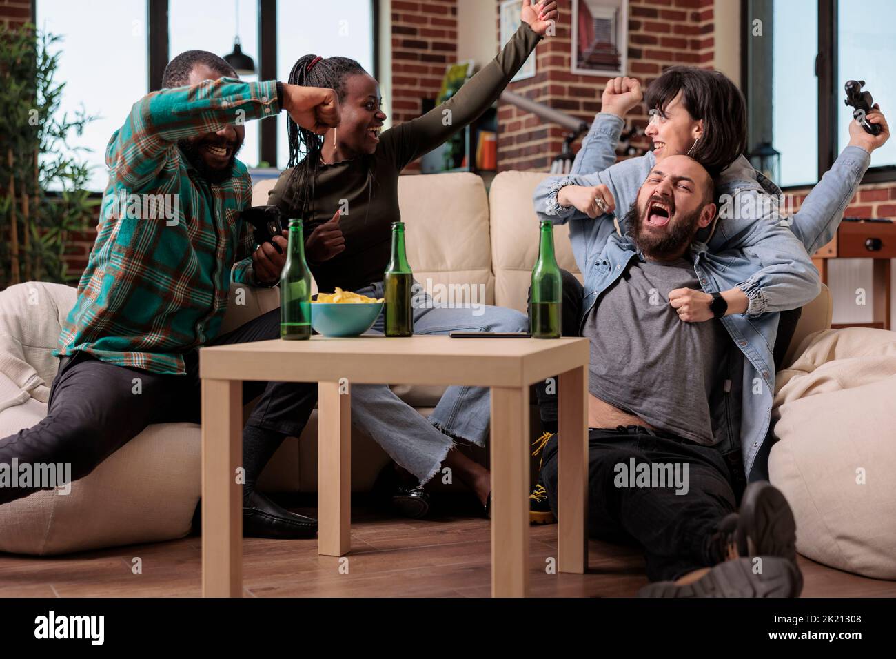 Diverse group of people celebrating video games win at gathering ...