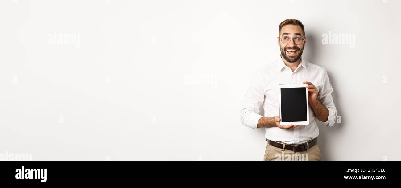 Shopping and technology. Thoughtful man showing digital tablet screen ...