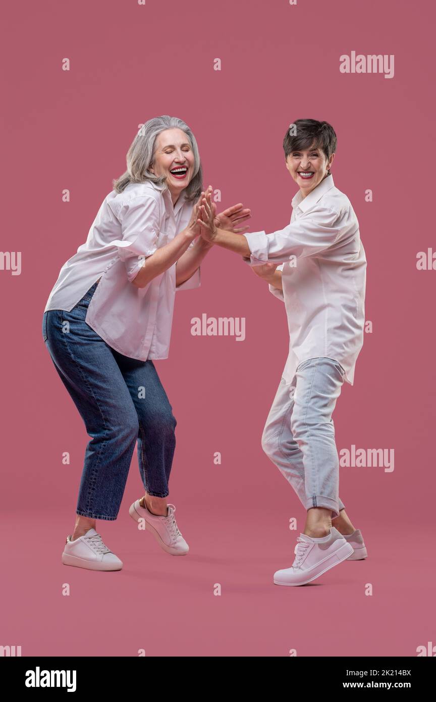 Women feeling playful and joyful while spending time together Stock ...