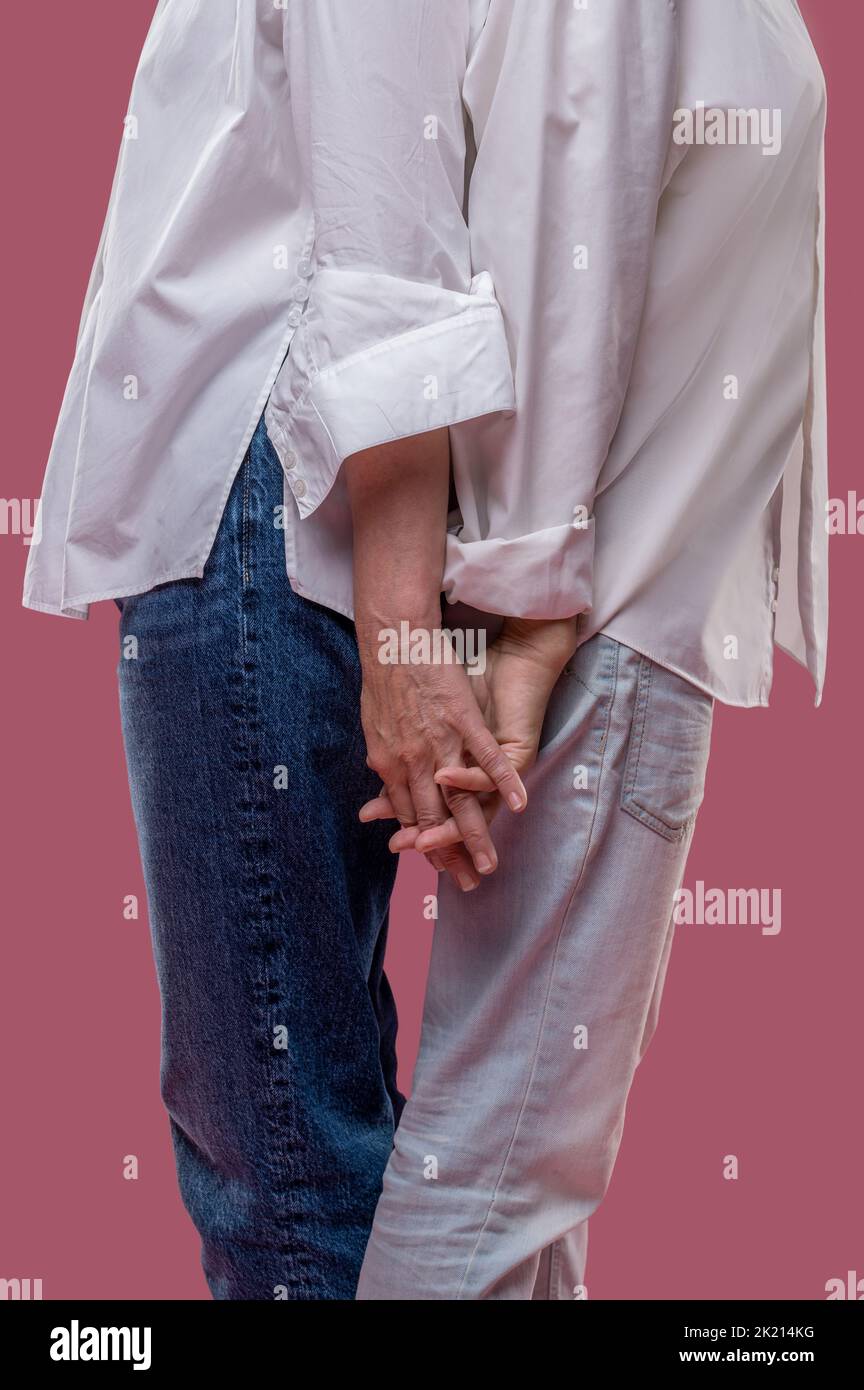 Two women standing back to back and feeling close Stock Photo - Alamy