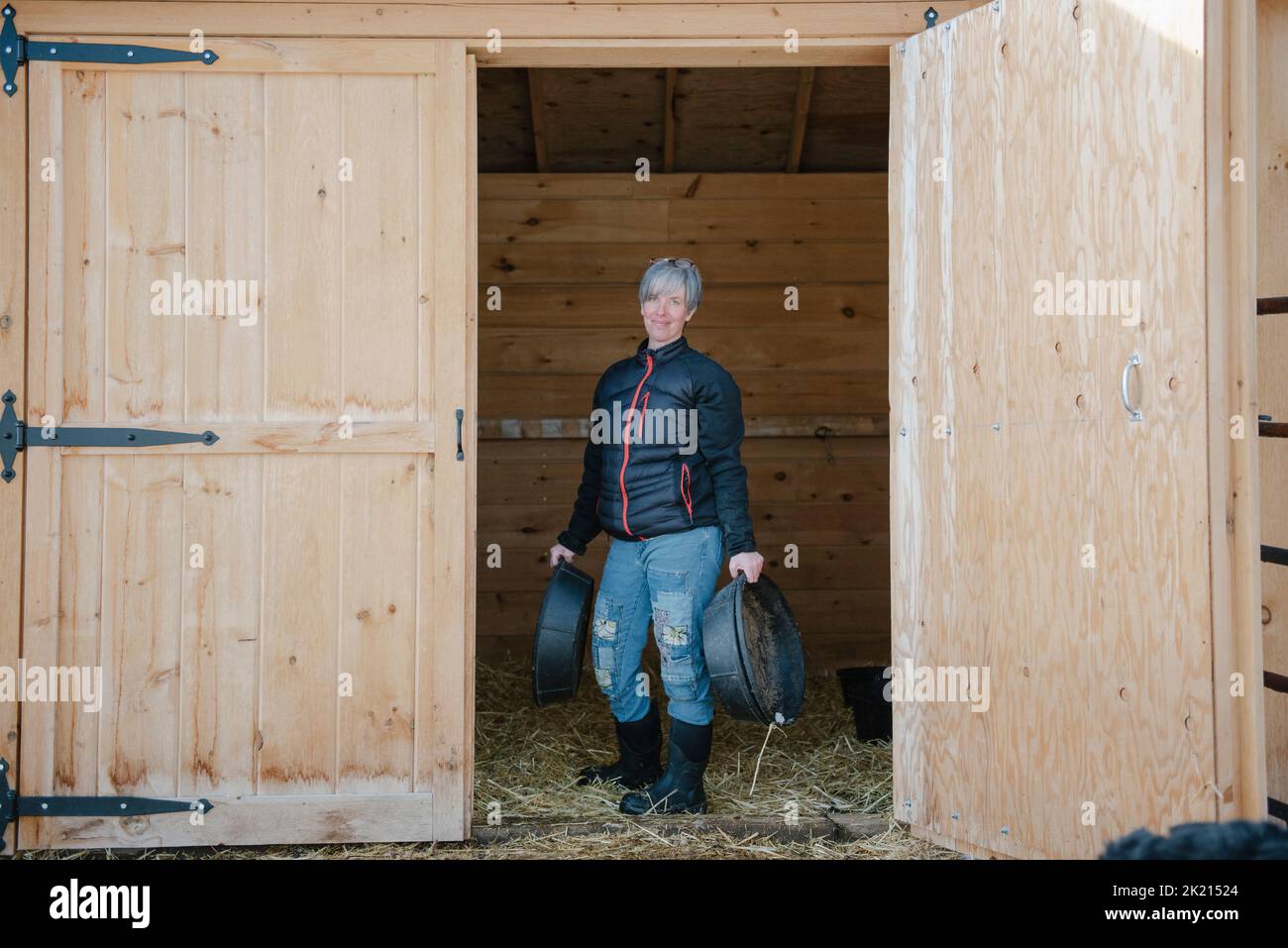 Portrait confident female farmer in barn doorway Stock Photo - Alamy Portrait confident female farmer in barn doorway Stock Photo - Alamy