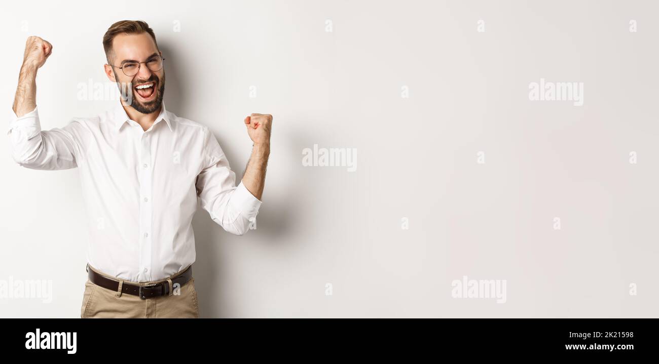 Successful businessman rejoicing, raising hands up and celebrating ...