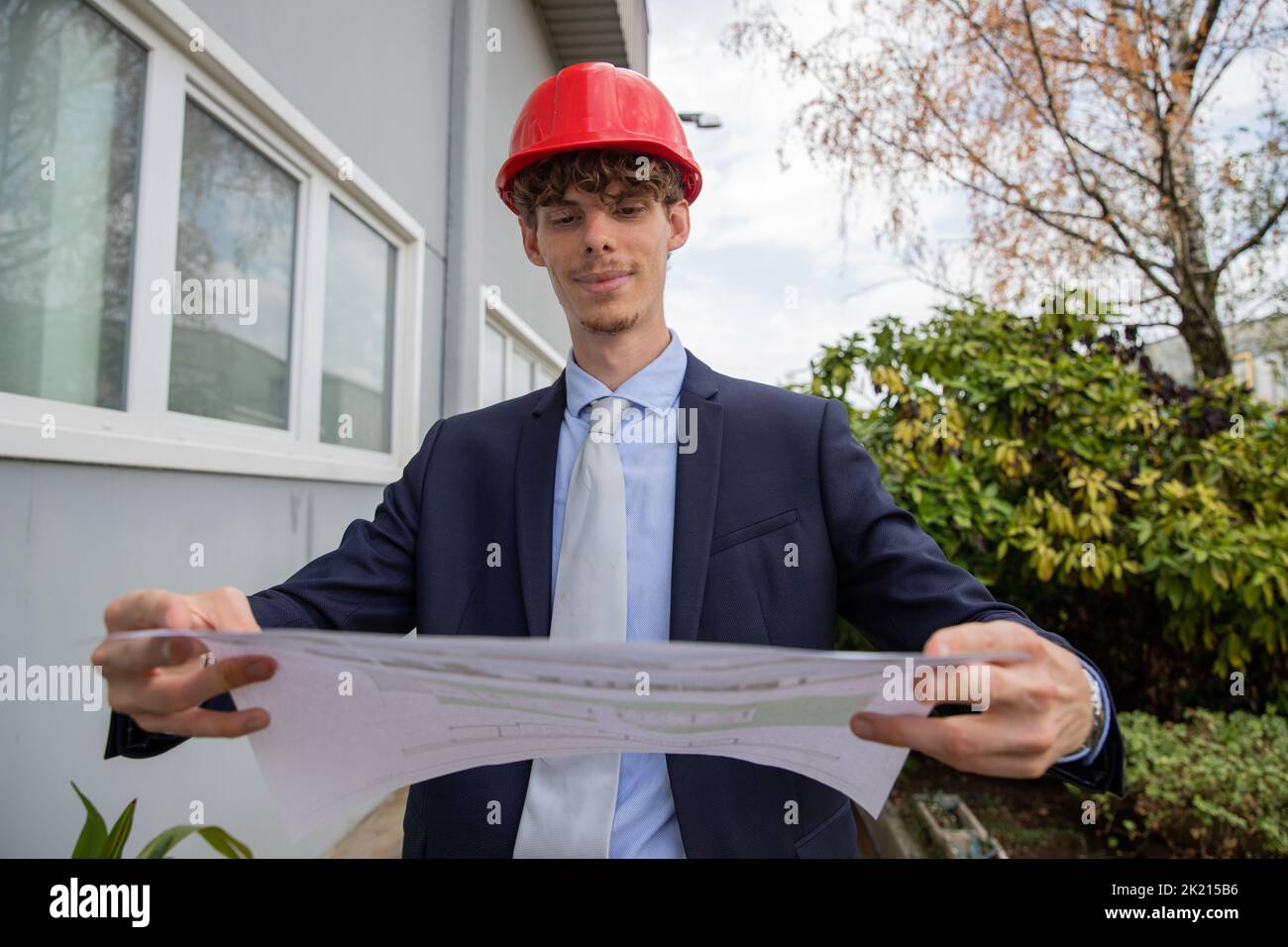 The engineer checks the cartography and floor plan of the work that ...