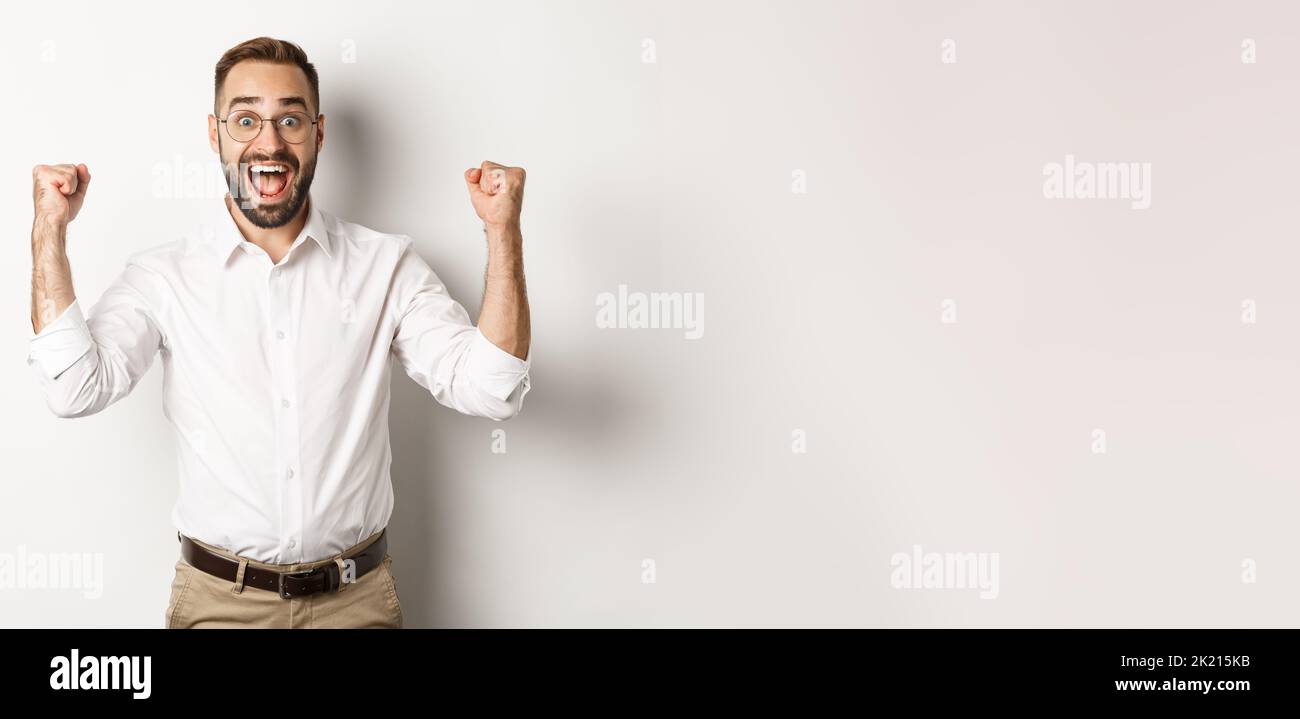 Successful businessman rejoicing, raising hands up and celebrating ...