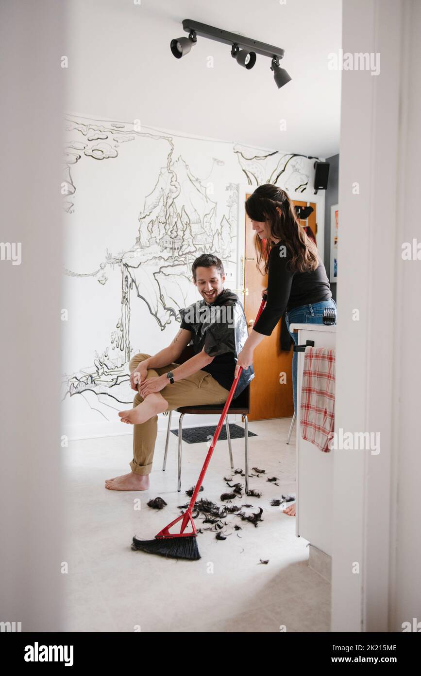 Woman sweeping hair on kitchen floor Stock Photo - Alamy