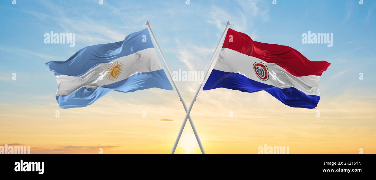 crossed national flags of Argentine and Paraguay flag waving in wind at ...
