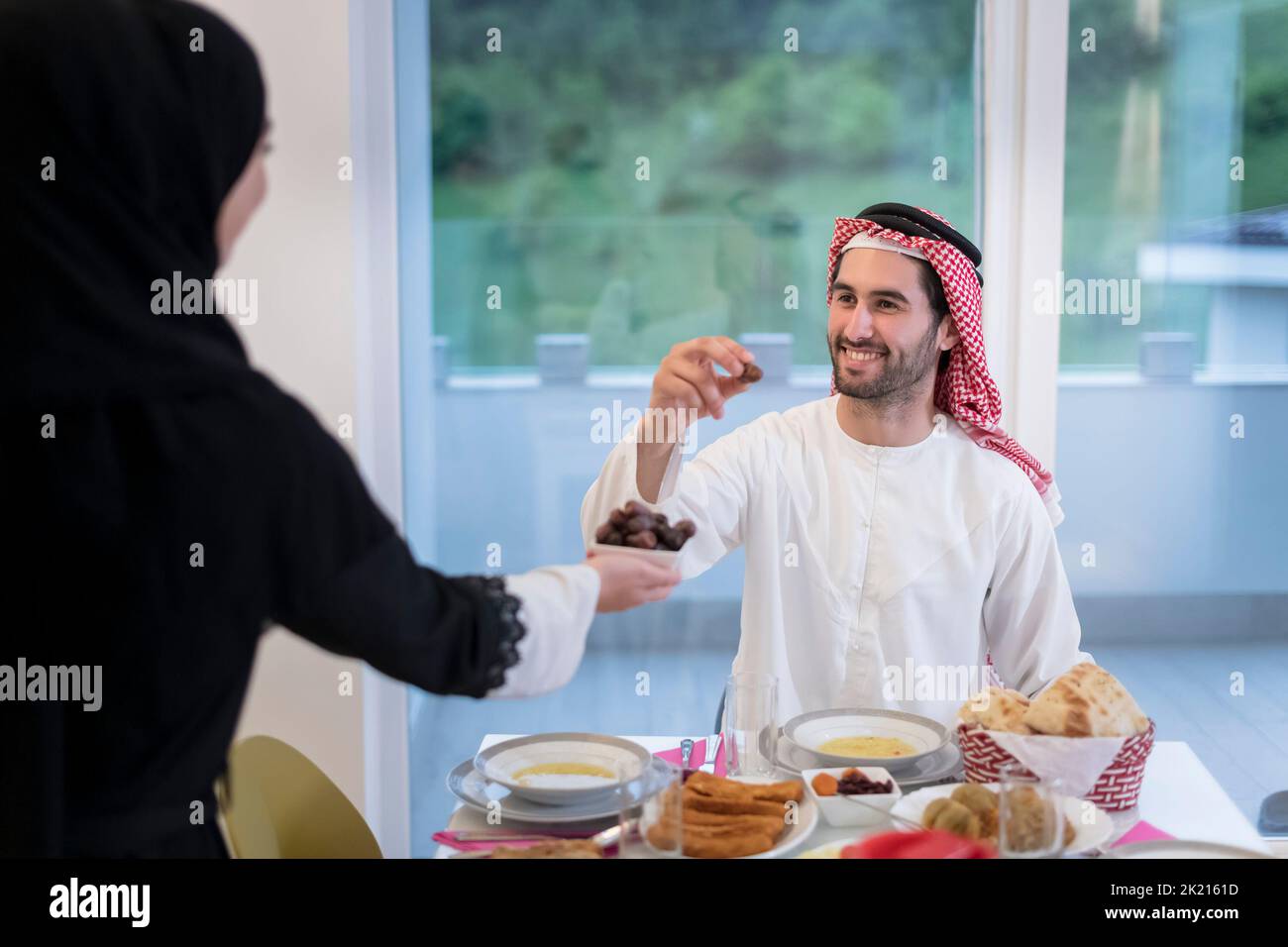 modern multiethnic muslim family sharing a bowl of dates while enjoying ...