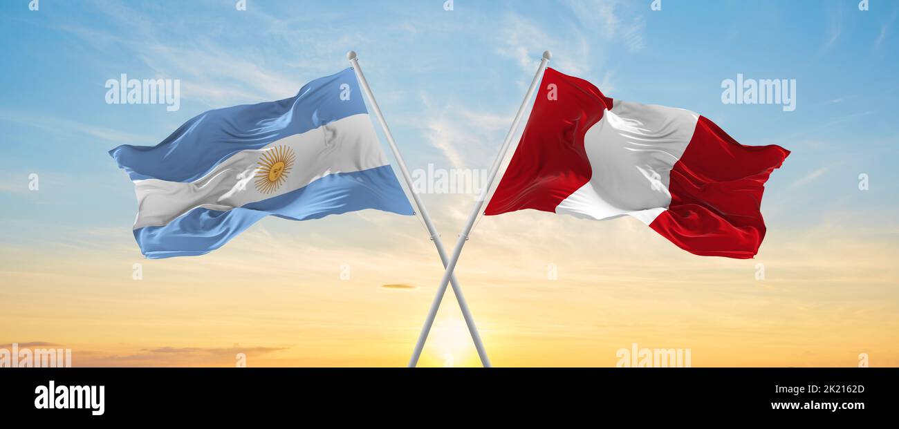 crossed national flags of Argentine and Peru flag waving in wind at ...