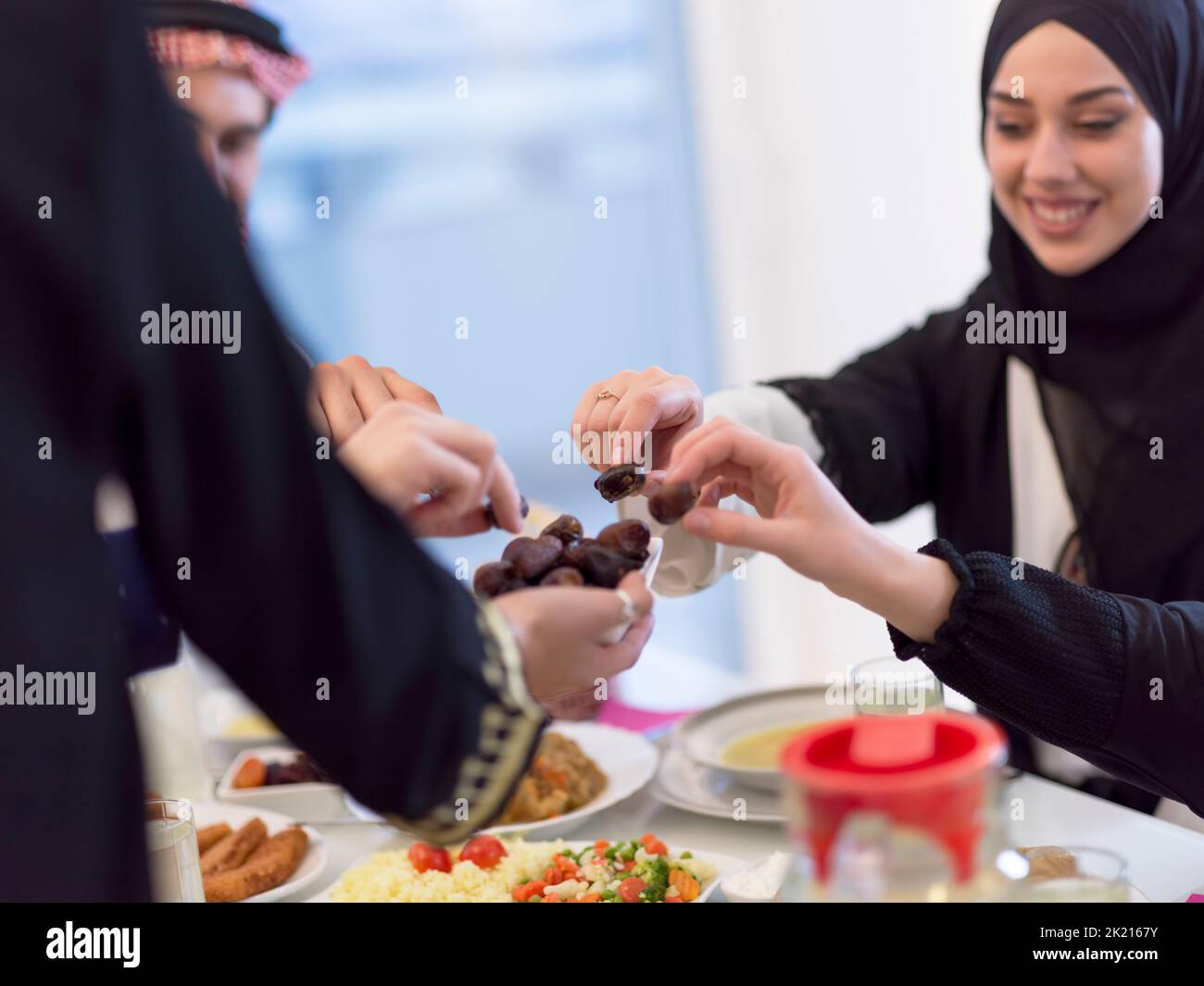 modern multiethnic muslim family sharing a bowl of dates while enjoying ...