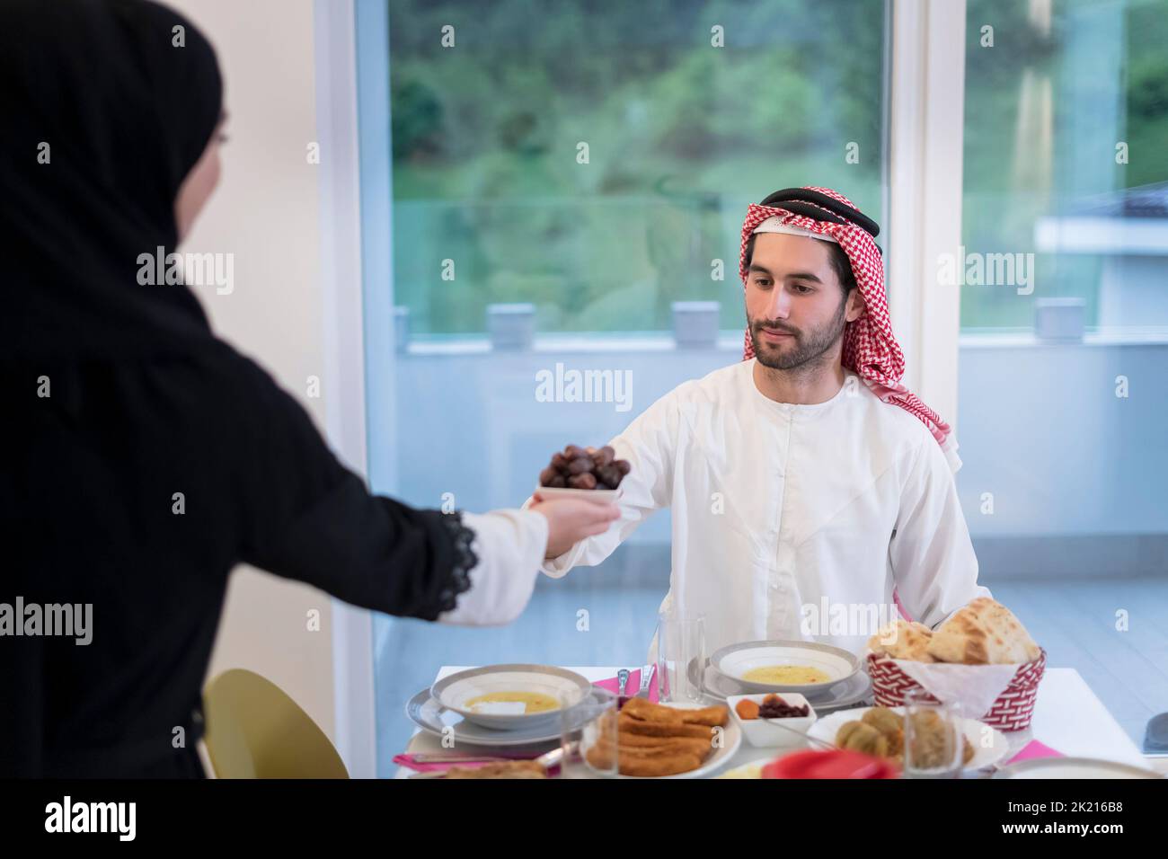 modern multiethnic muslim family sharing a bowl of dates while enjoying ...