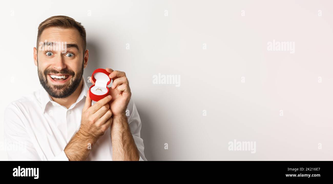 Close-up of handsome guy making proposal, looking hopeful and showing ...