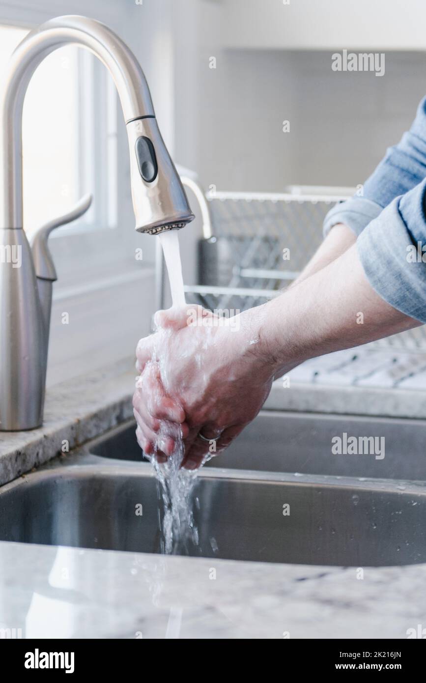 Washing hands in sink hi-res stock photography and images - Alamy