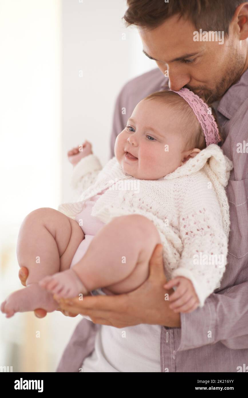 Shes my everything. a young father holding his adorable baby daughter ...