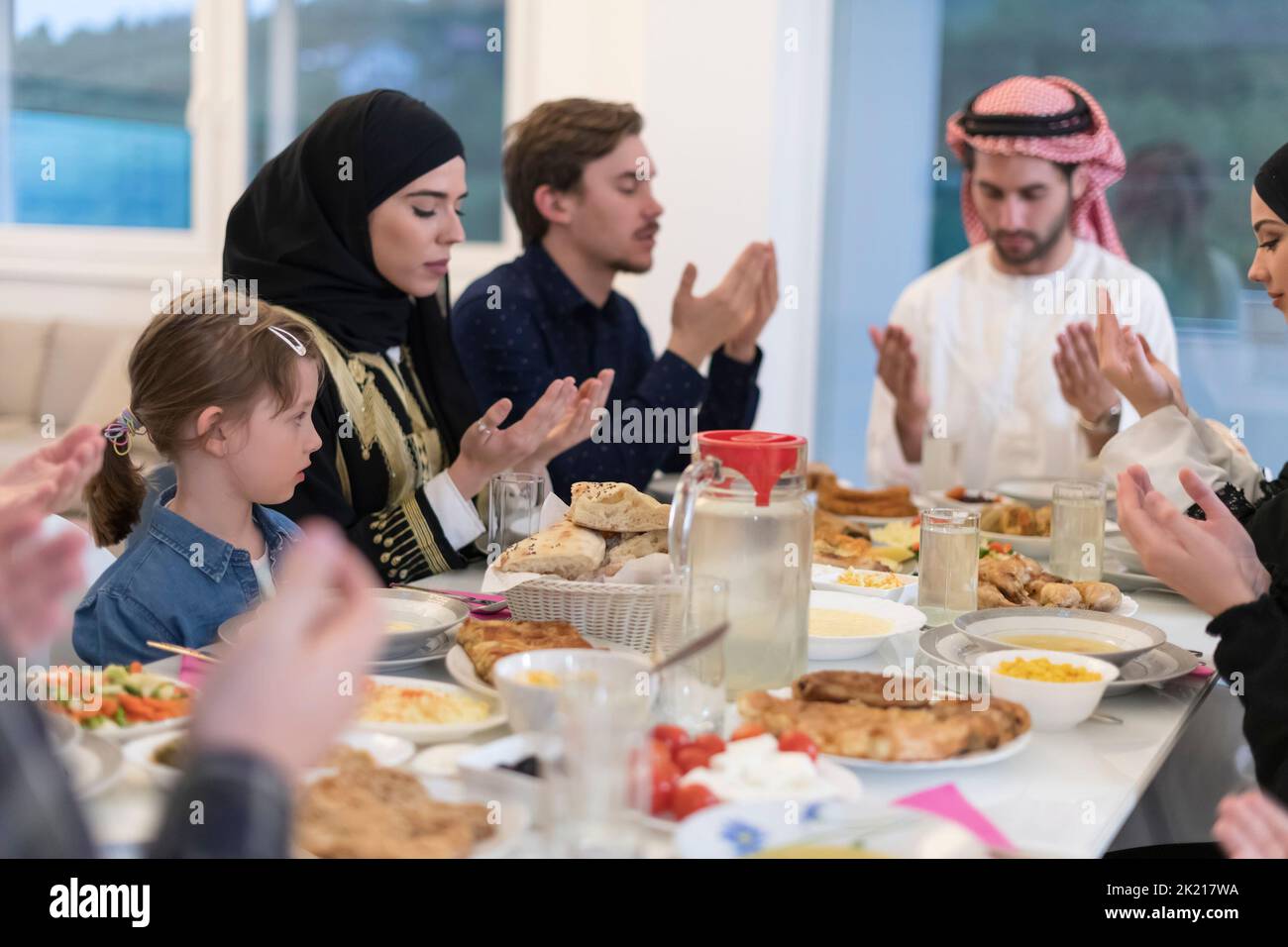 Muslim family making iftar dua to break fasting during Ramadan Stock ...