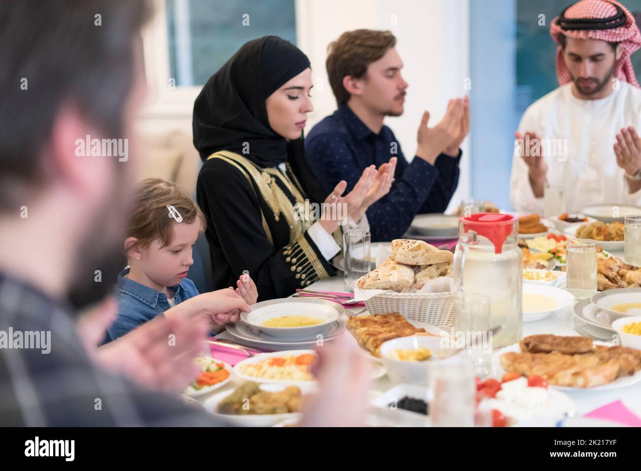 Muslim family making iftar dua to break fasting during Ramadan Stock ...
