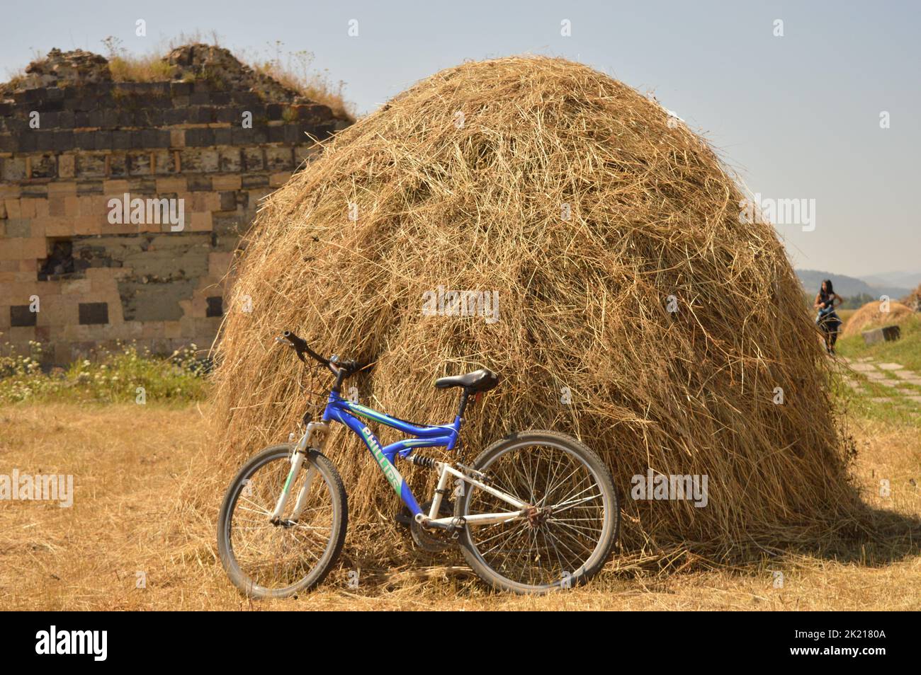 A Bike leaning on a collected hay Stock Photo - Alamy