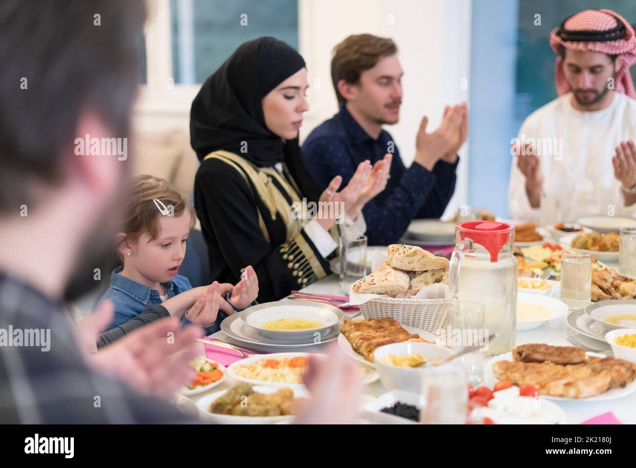 Muslim family making iftar dua to break fasting during Ramadan Stock ...