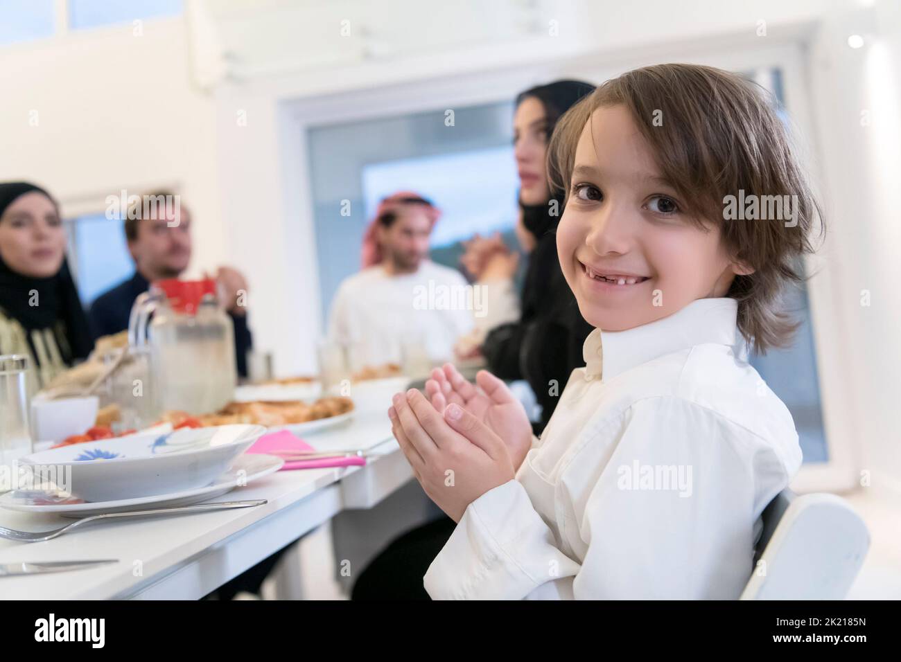 Muslim family making iftar dua to break fasting during Ramadan Stock ...