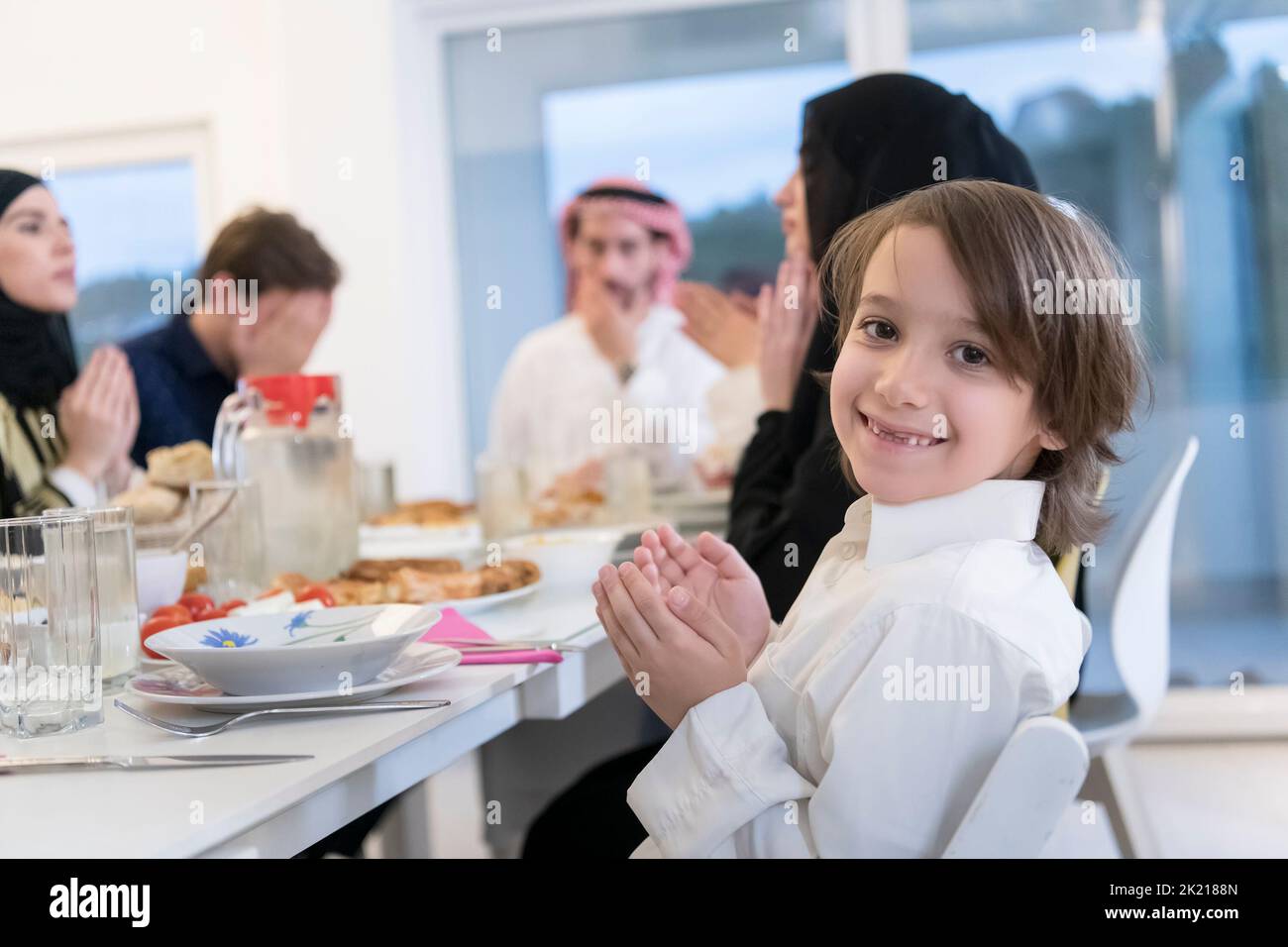 Muslim family making iftar dua to break fasting during Ramadan Stock ...