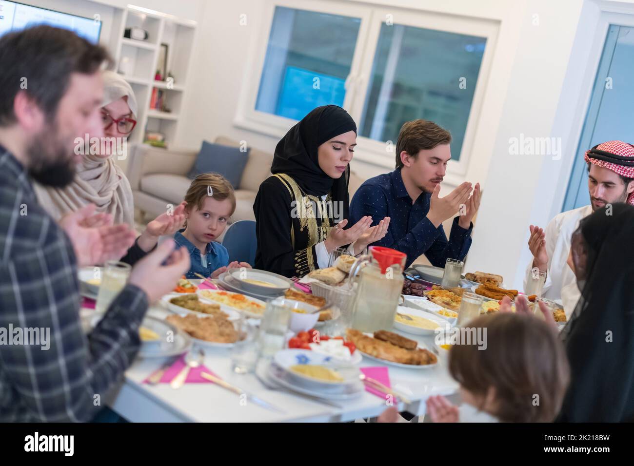 Muslim family making iftar dua to break fasting during Ramadan Stock ...