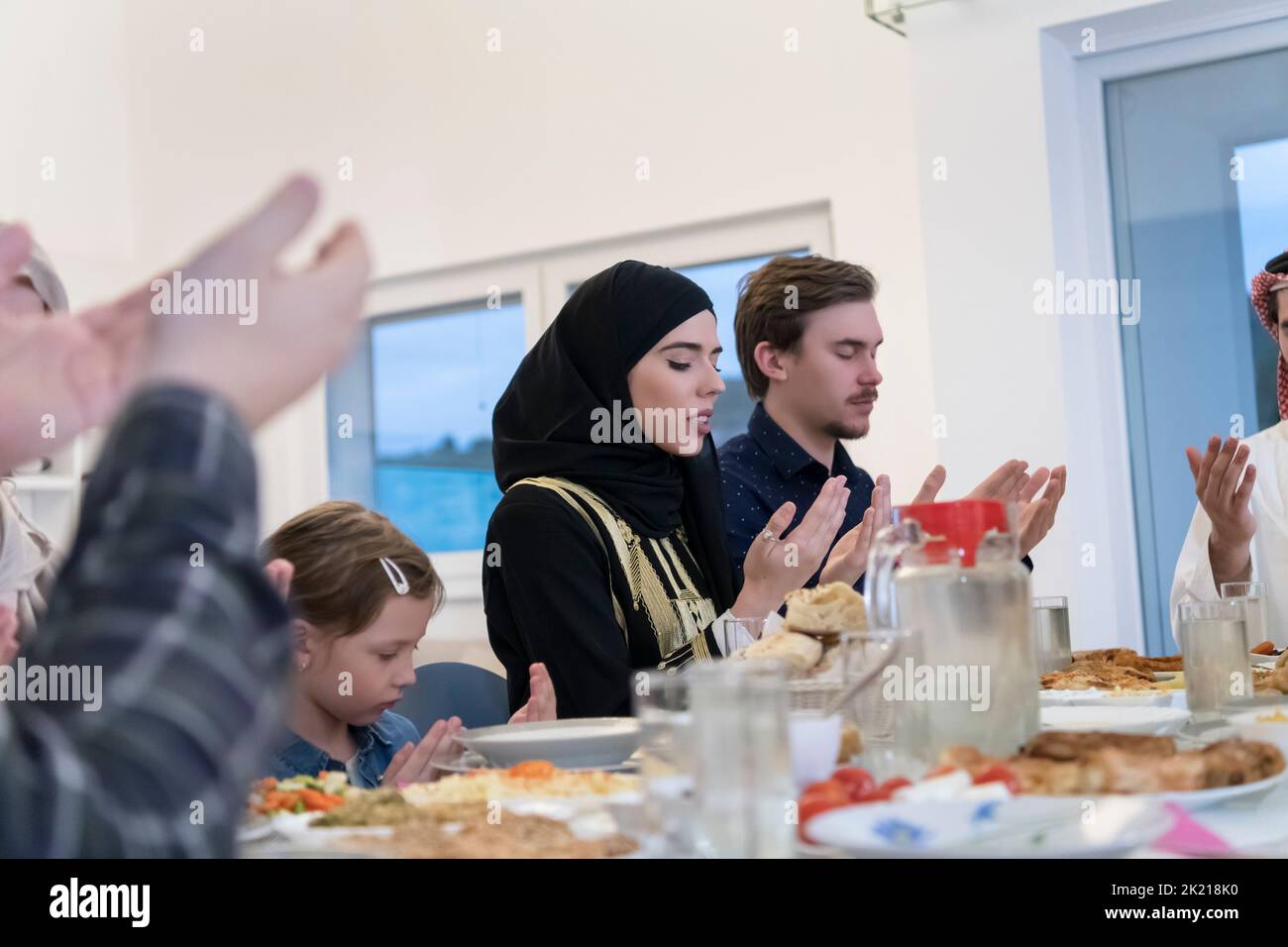 Muslim family making iftar dua to break fasting during Ramadan Stock ...
