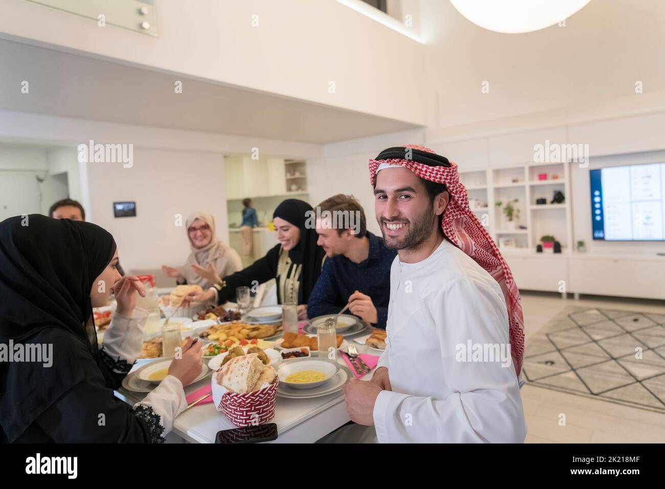 young arabian man having Iftar dinner with muslim family Eating ...