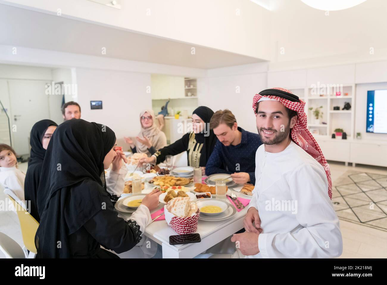 young arabian man having Iftar dinner with muslim family Eating ...