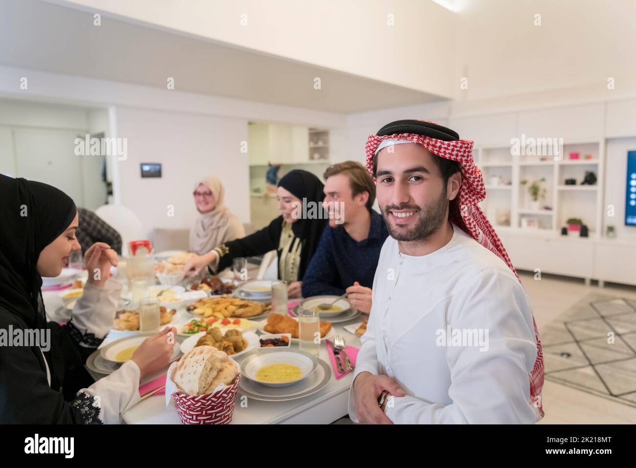 young arabian man having Iftar dinner with muslim family Eating ...