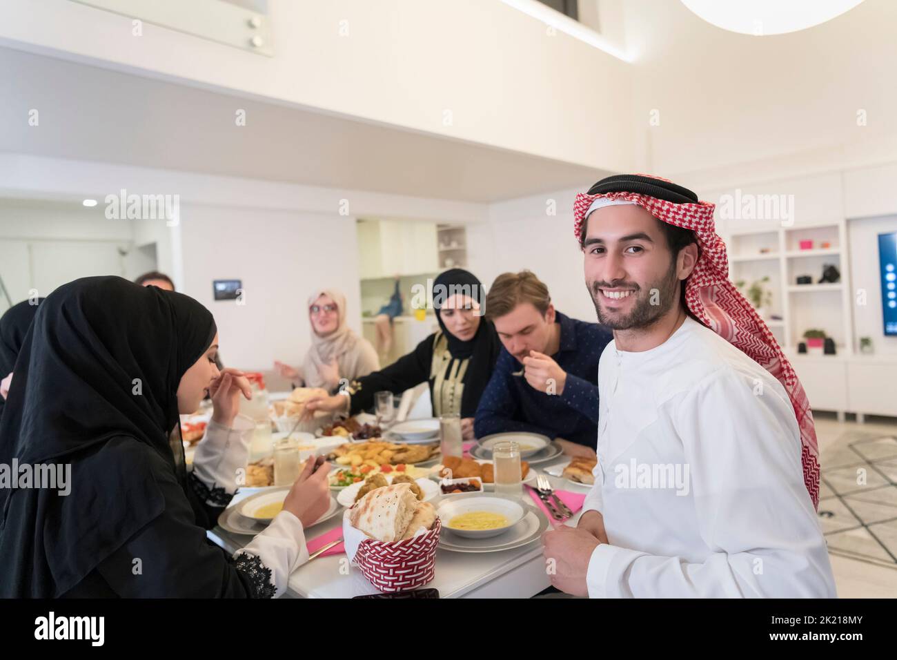 young arabian man having Iftar dinner with muslim family Eating ...