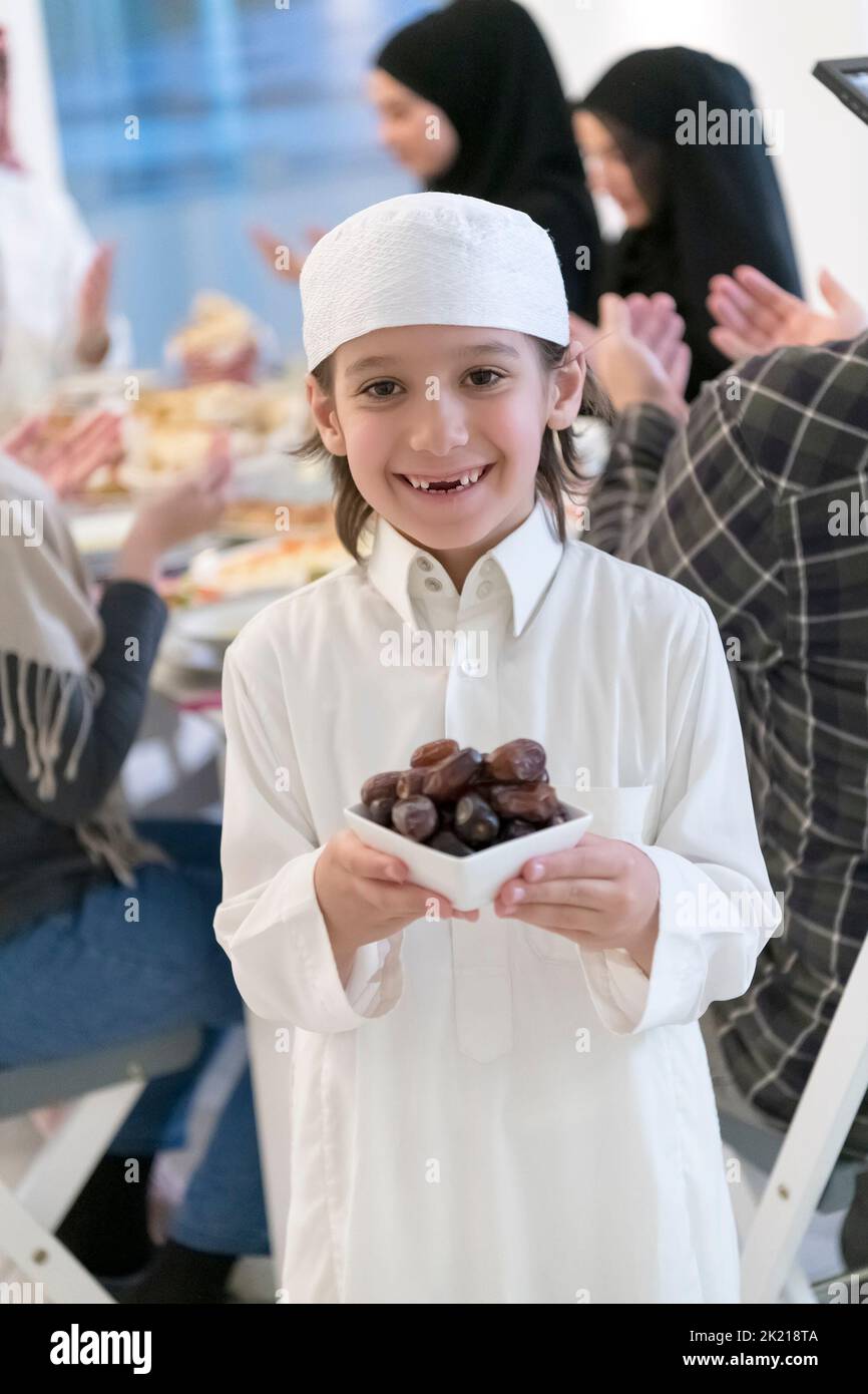 Eid Mubarak Muslim family having Iftar dinner little boy holding a ...