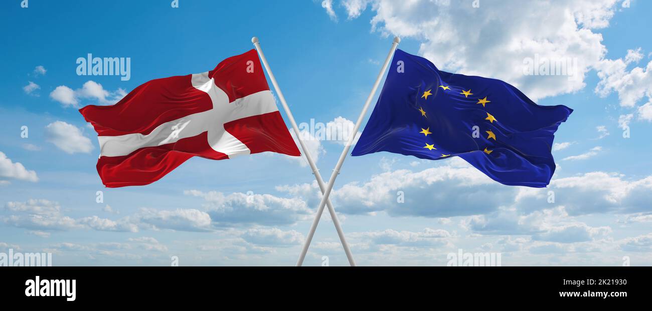two crossed flags The European Union and Denmark waving in wind at ...