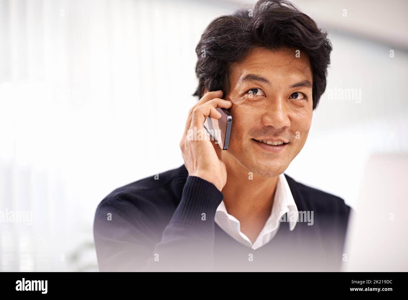 Ill have to get back to you on that. a handsome asian businessman on ...