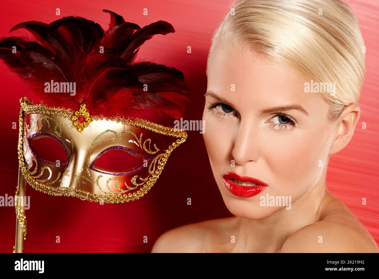 Ready for a masked ball. Portrait of a glamourous beautiful blonde ...