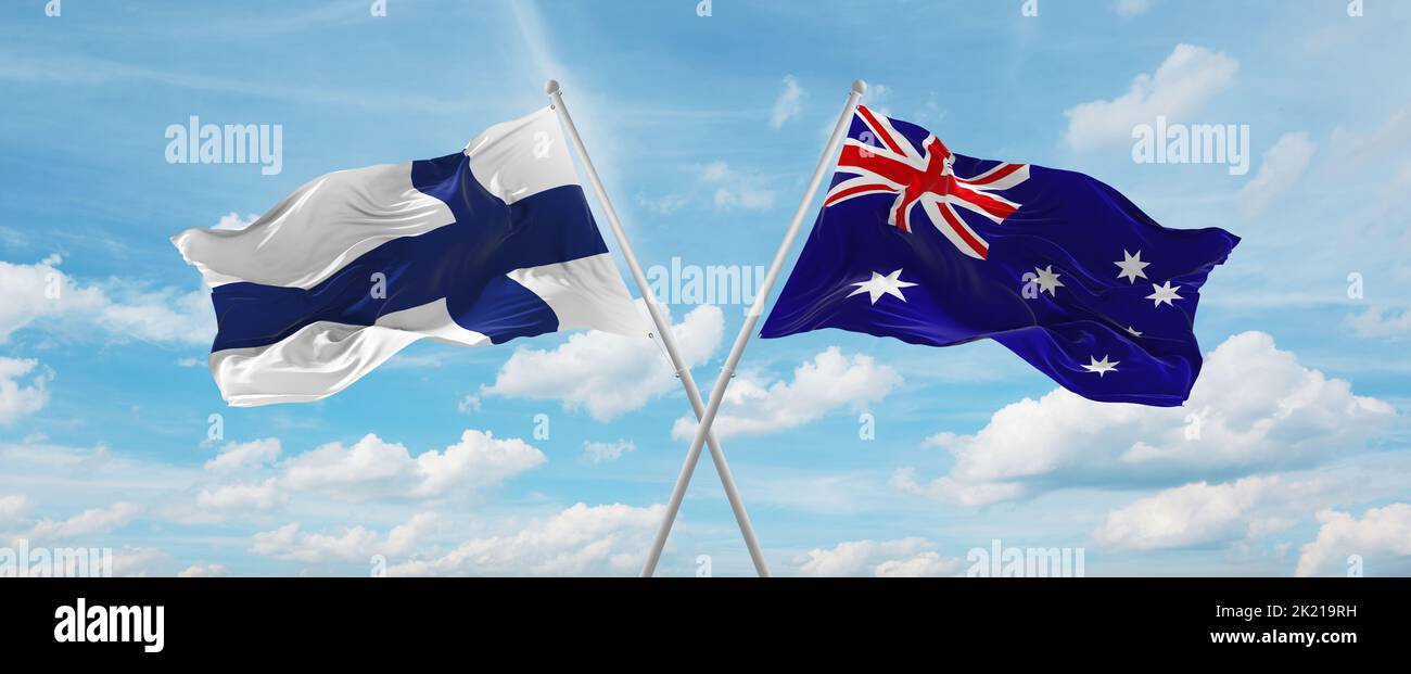 two crossed flags Australia and finland waving in wind at cloudy sky ...