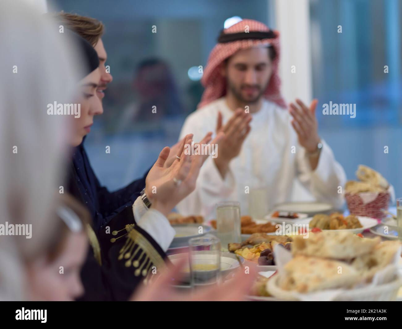 Muslim family making iftar dua to break fasting during Ramadan Stock ...