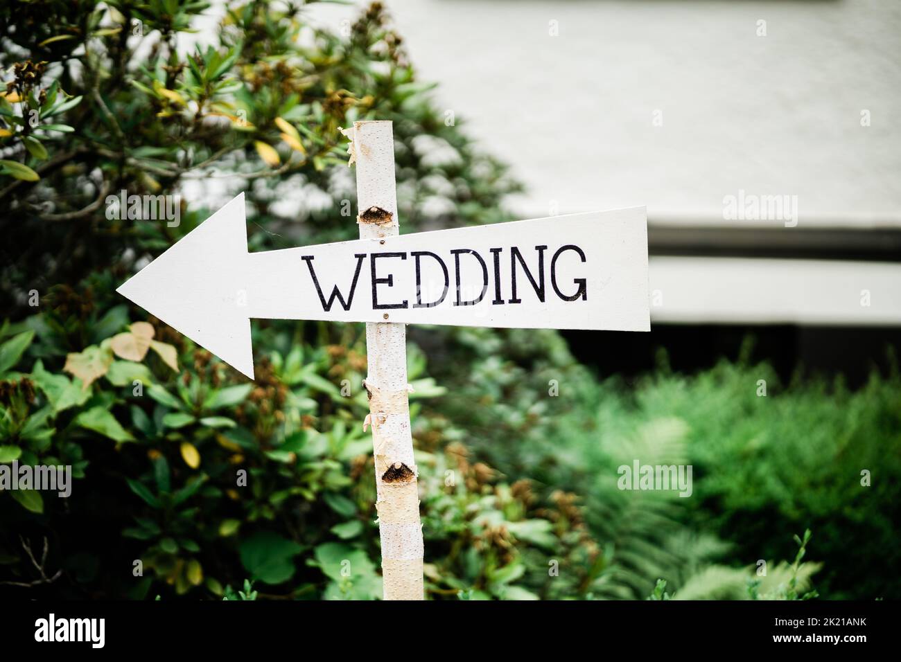 A Wedding Sign in a garden with a bush Stock Photo - Alamy