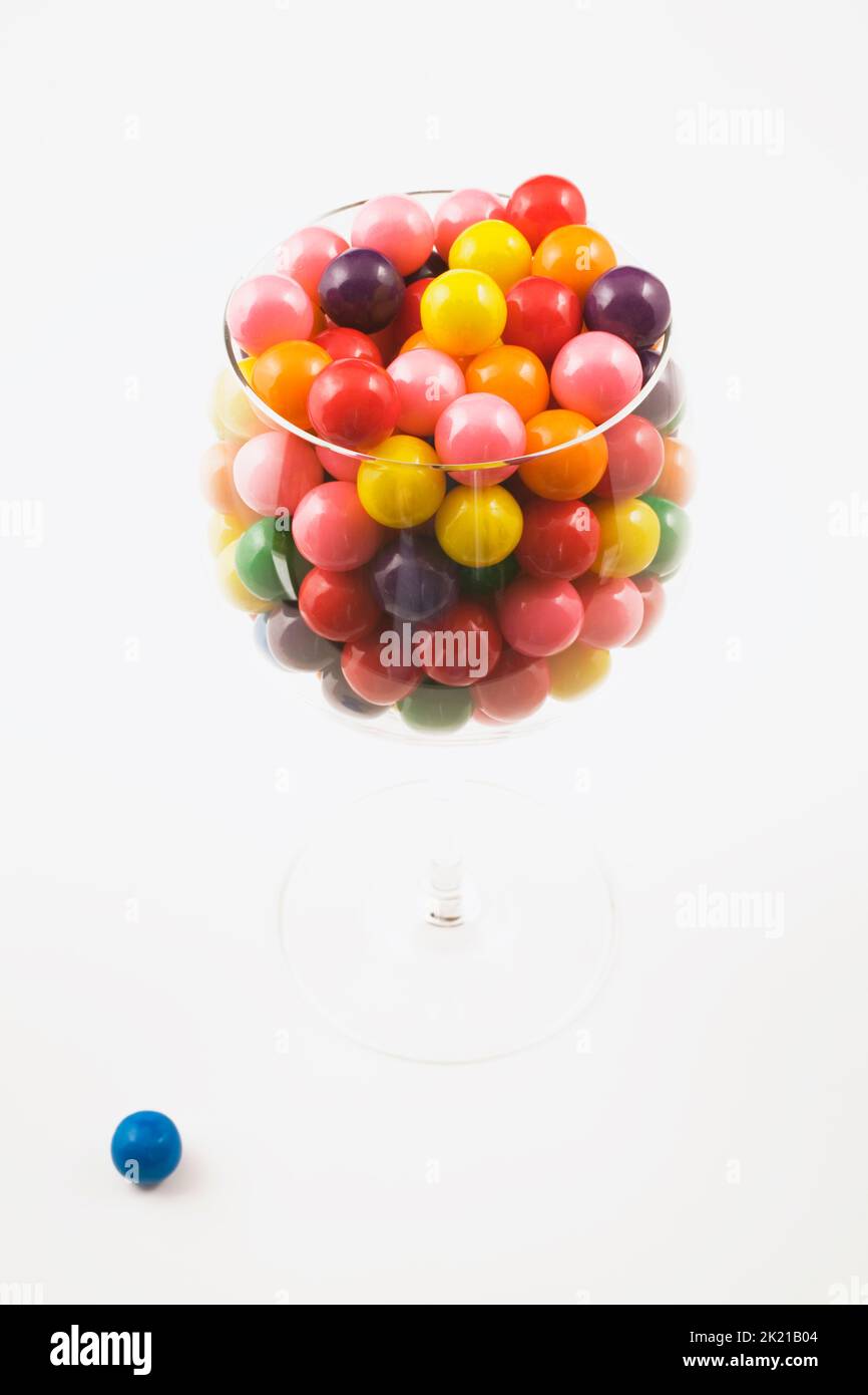 Assorted colored gum balls in wine glass on white background Stock ...