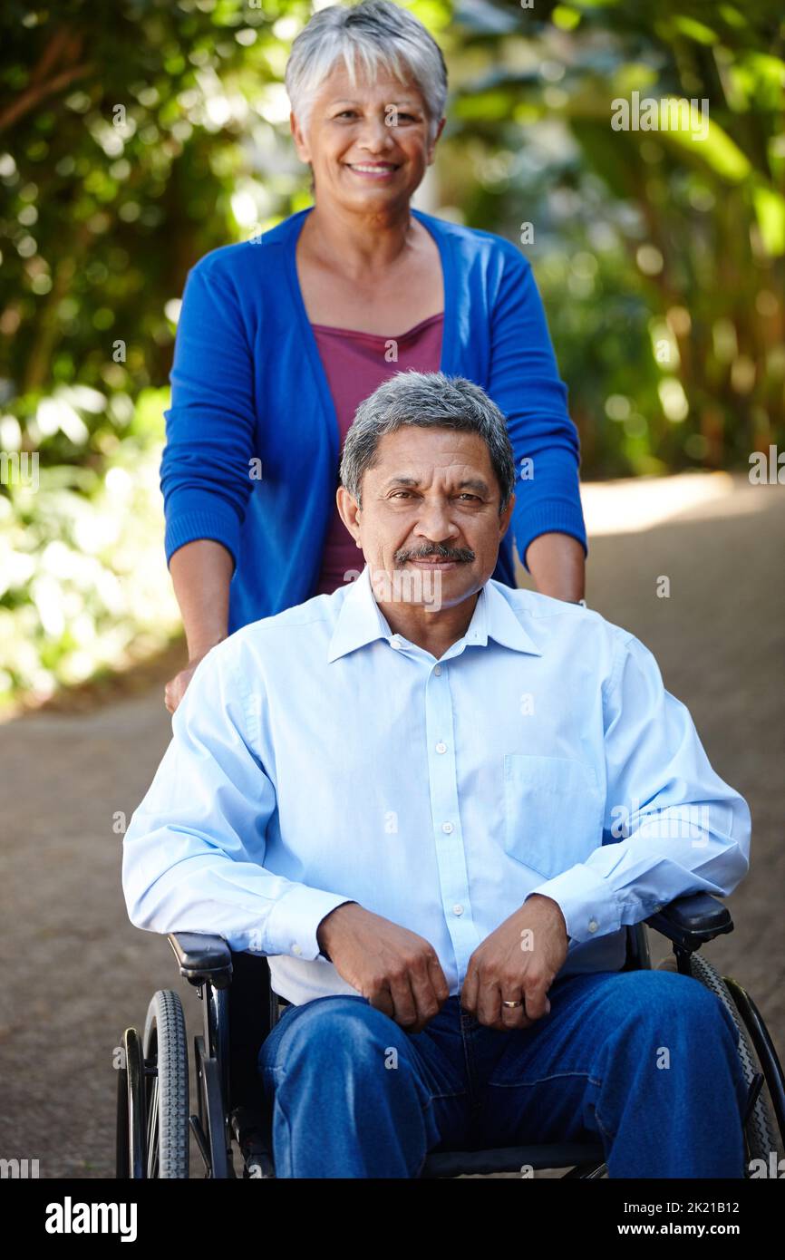 On the road to recovery. Portrait of a senior woman pushing her husband ...