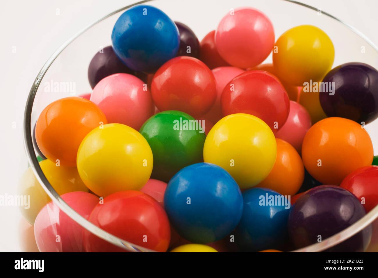 Assorted colored gum balls in wine glass on white background Stock ...